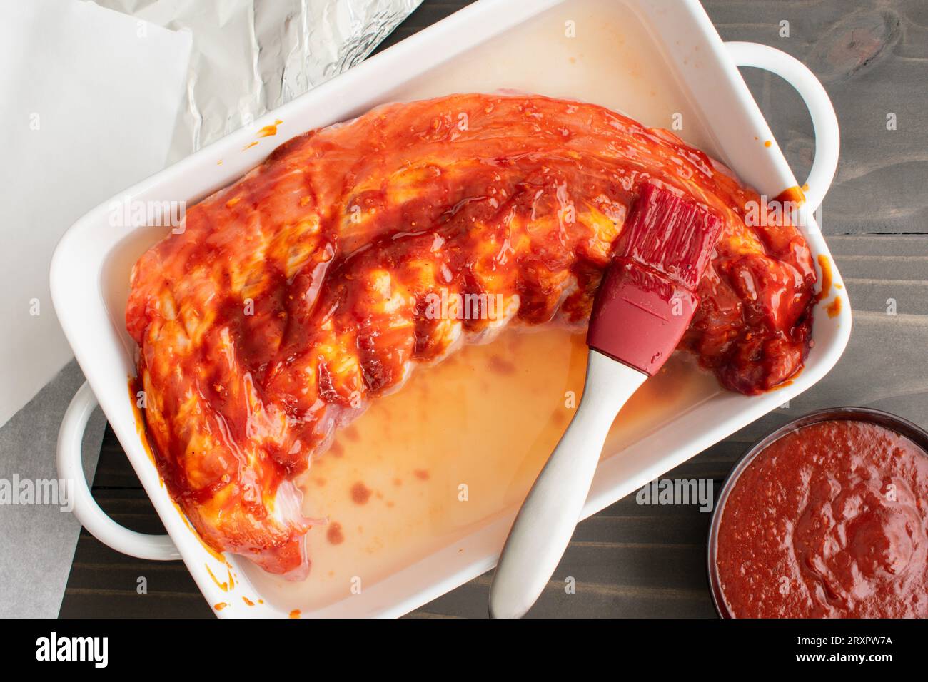 Basted Baby Back Ribs in a Water-Filled Casserole Dish: A rack of raw ...