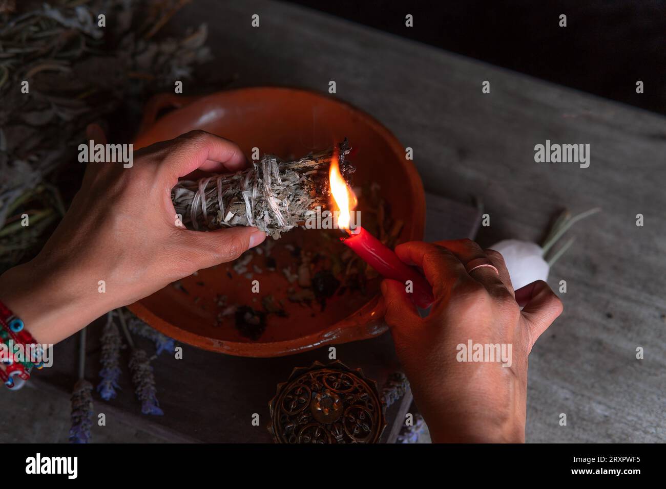 lighting an incense, , witch on the eve of all saints' eve performing a ...