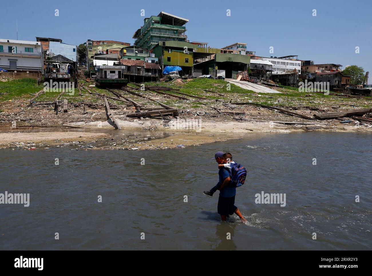 Uanderson Marinho de Souza, 40, carries his son to school across the ...