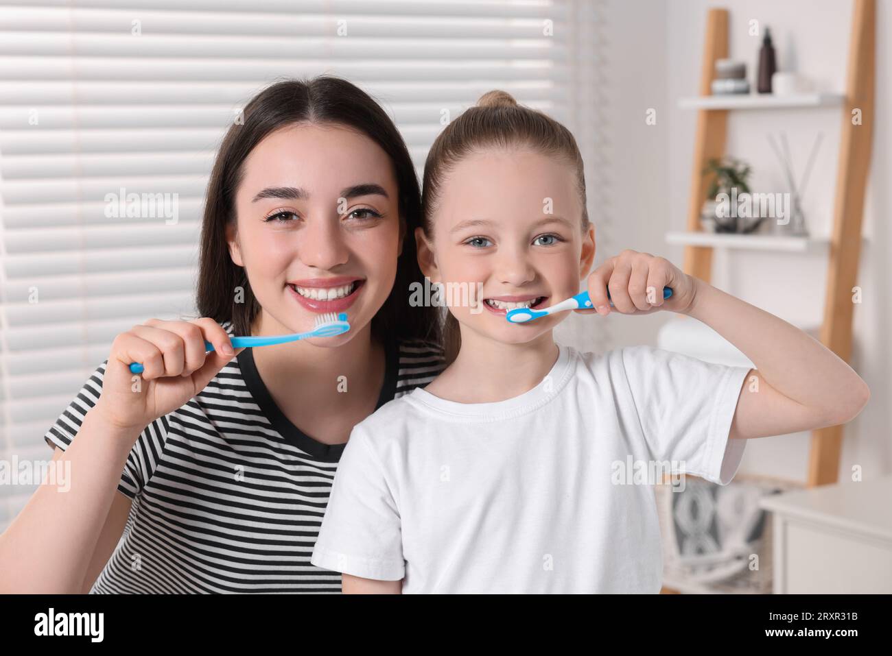 Portrait mother daughter brushing teeth hi-res stock photography and ...