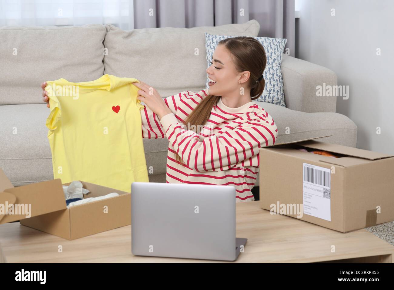 Woman unpacking parcels young customer hi-res stock photography and ...