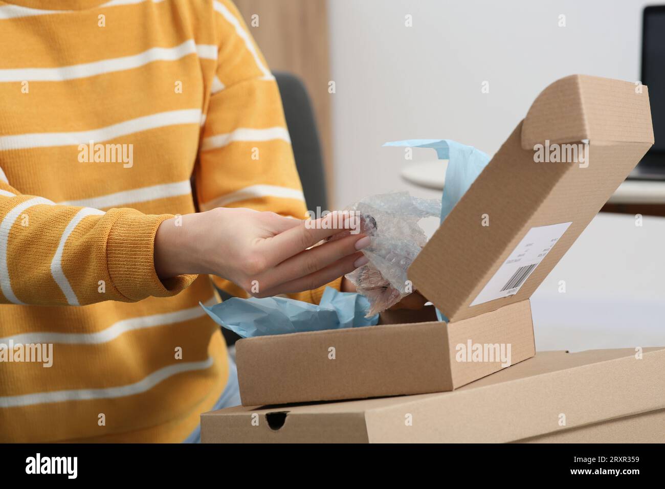 Woman unboxing parcel home hi-res stock photography and images - Alamy