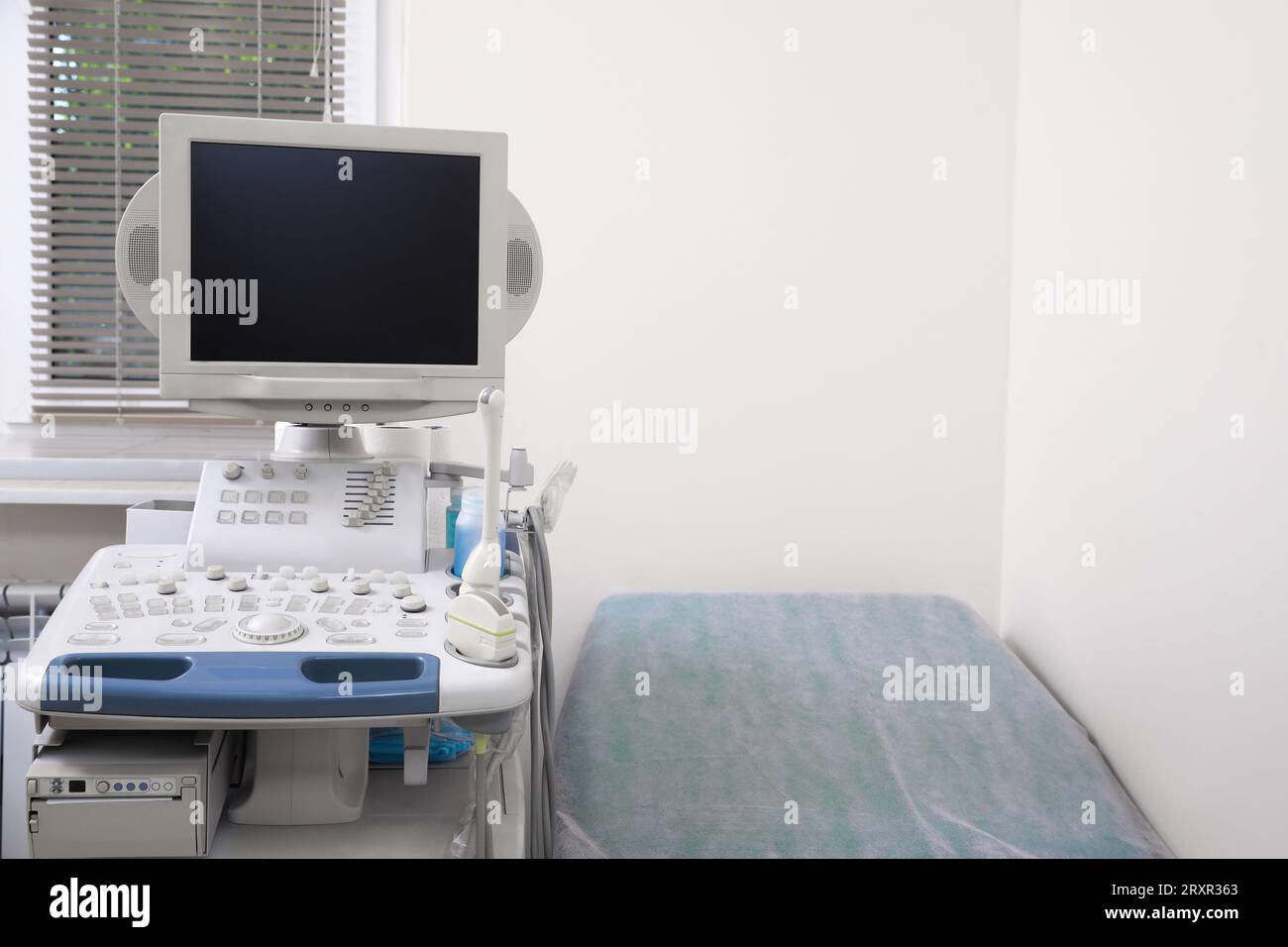 Ultrasound machine and examination table in hospital. Space for text ...