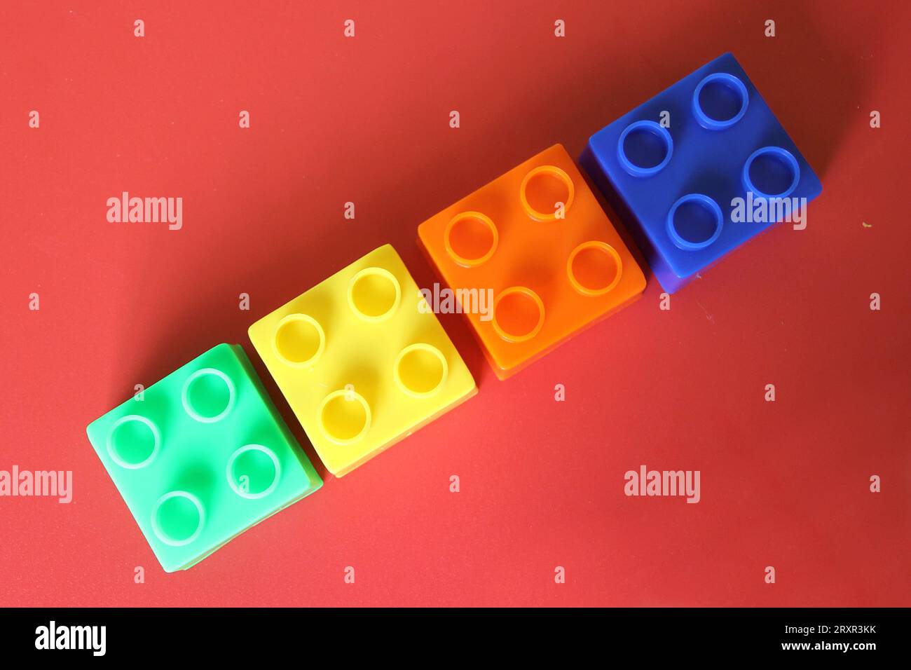 Buildable colored plastic blocks to play, build and organize on a red ...