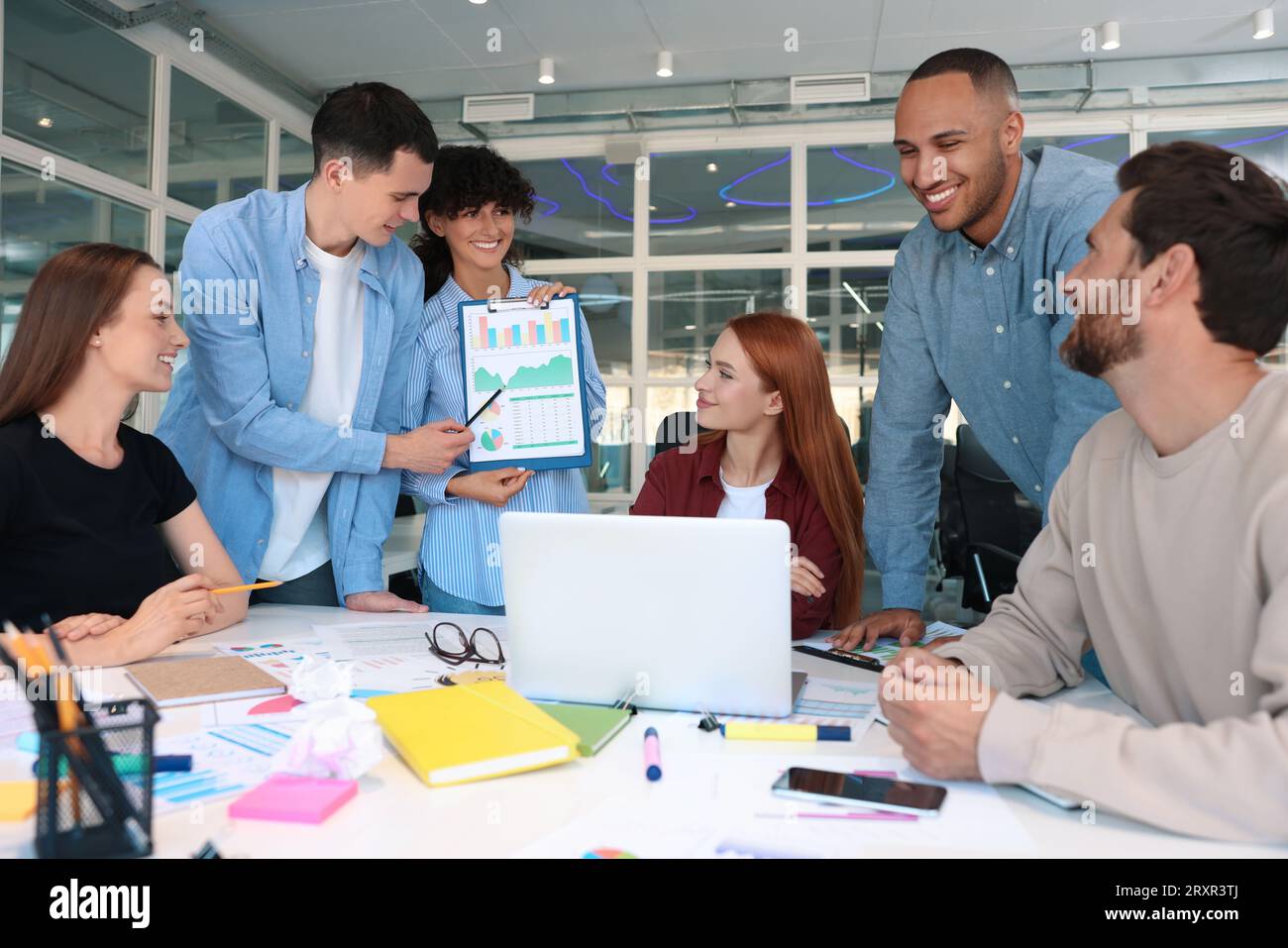 Team of employees working together at table in office. Startup project ...