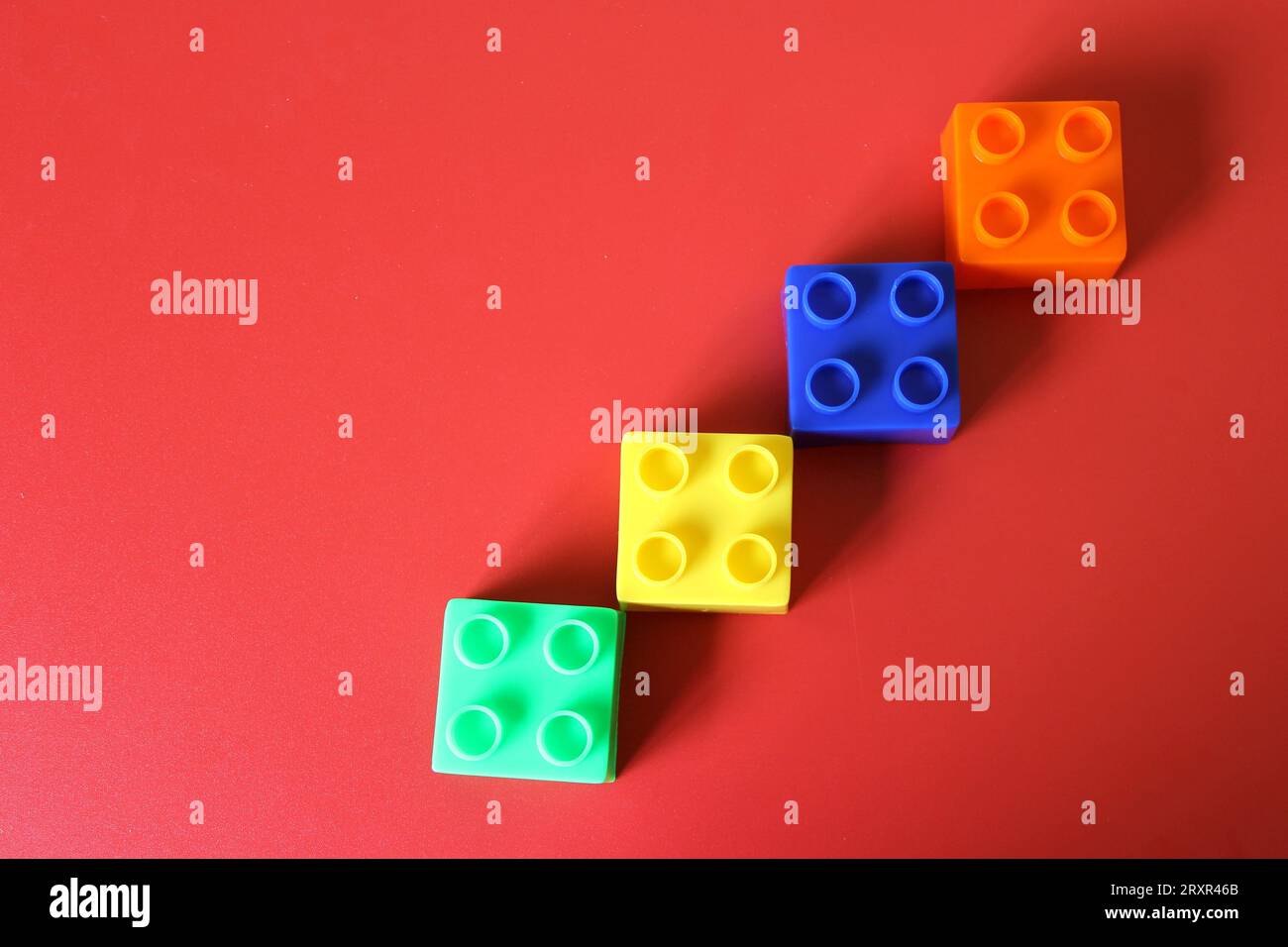 Buildable colored plastic blocks to play, build and organize on a red ...