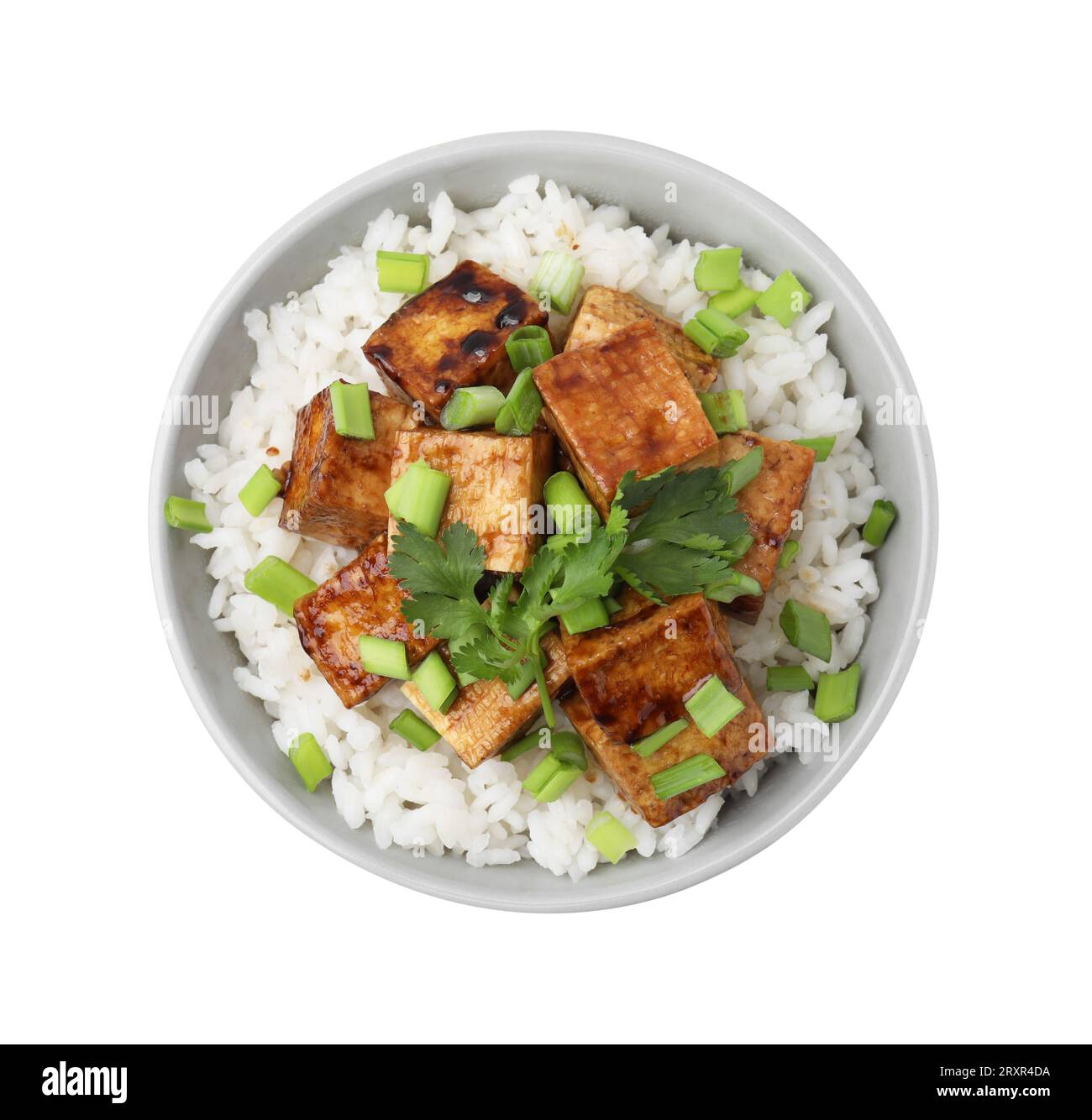 Bowl of rice with fried tofu and greens isolated on white, top view ...