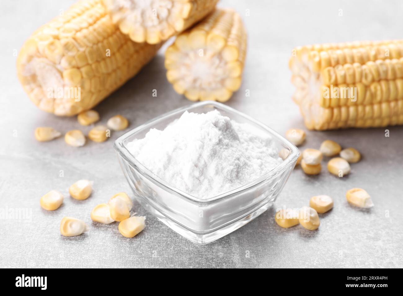 Bowl with corn starch and kernels on light grey table, closeup Stock ...