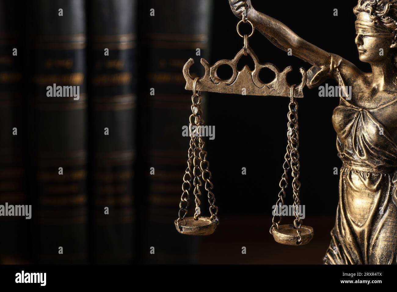 Symbol of fair treatment under law. Statue of Lady Justice on dark ...