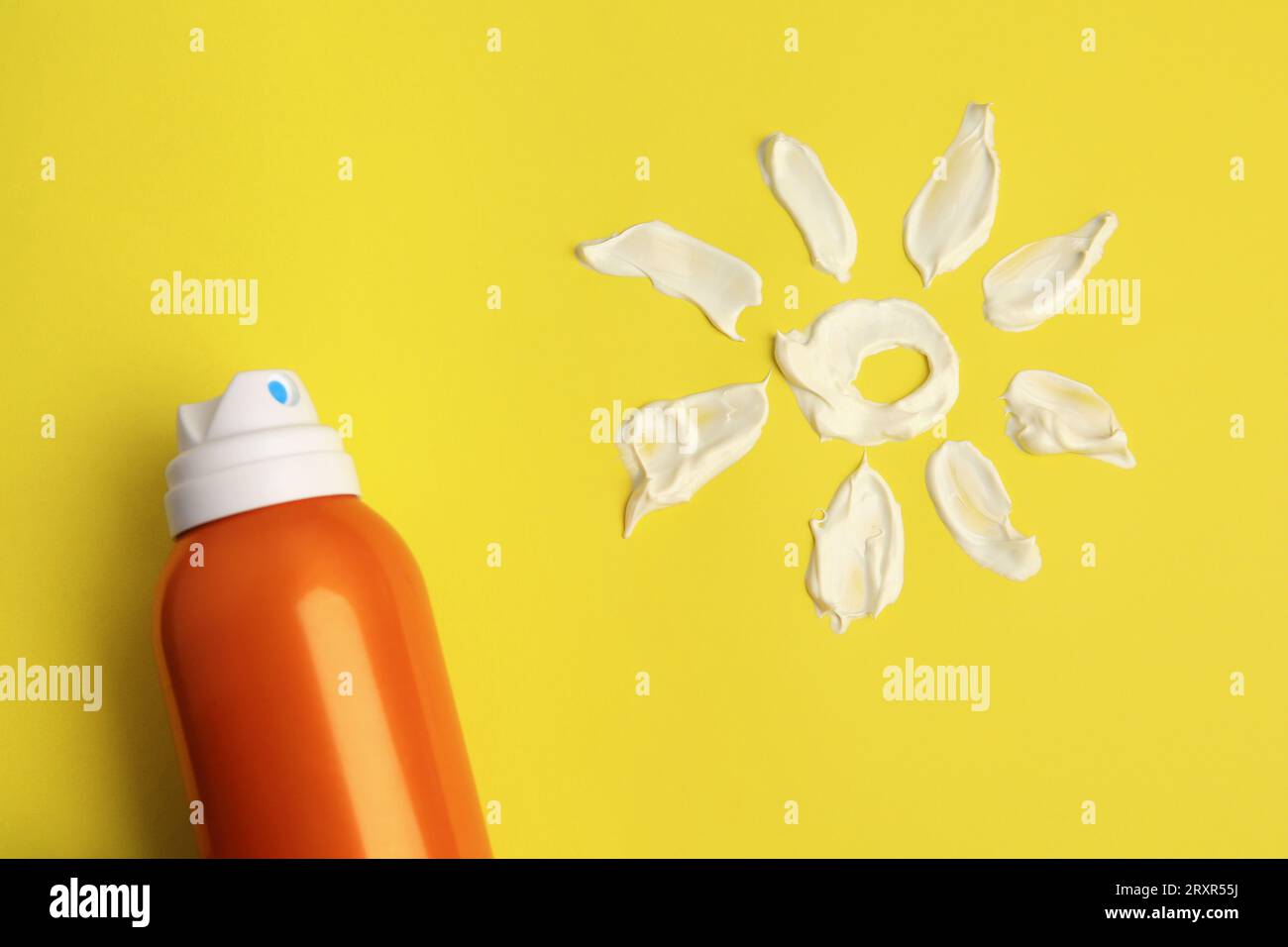 Drawing of sun and bottle with sunscreen on yellow background, top view ...