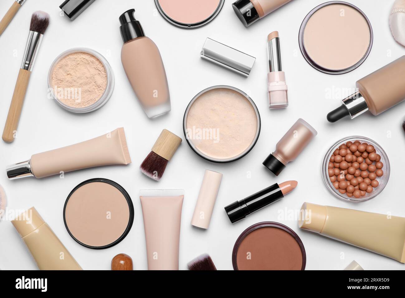Face powders and other makeup products on white background, flat lay ...