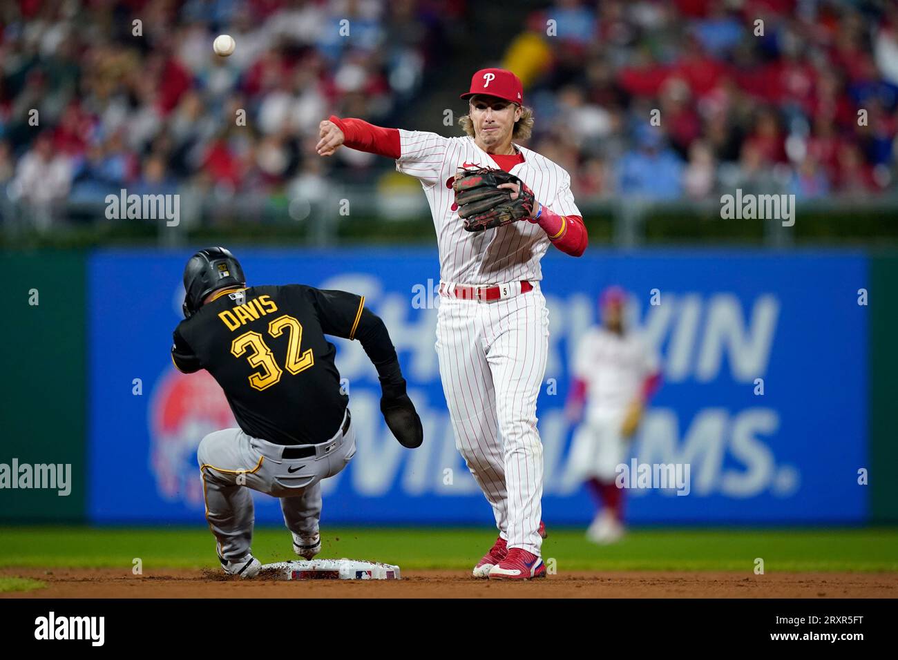 Philadelphia Phillies second baseman Bryson Stott, right, throws to first after forcing out ...