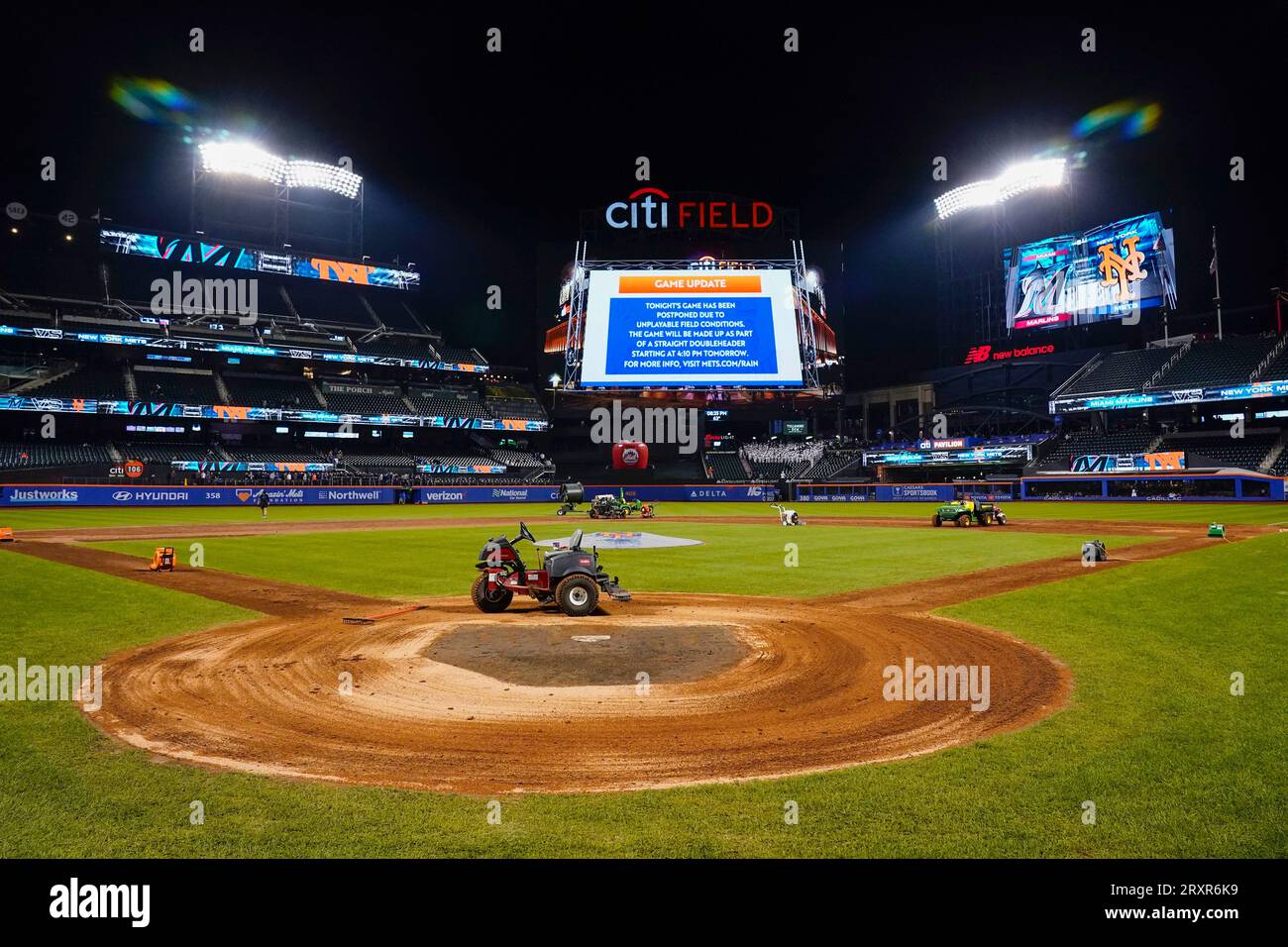 Ground crews work on the field at Citi Field after the baseball game ...