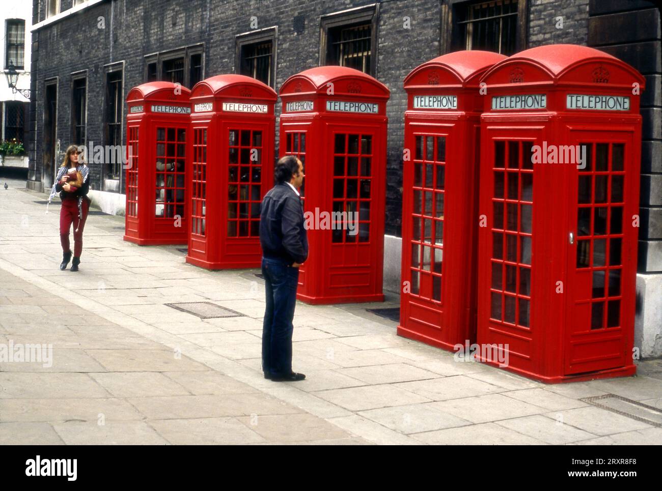 A row of iconic telephone booths in London, England, circa 1980s Stock ...