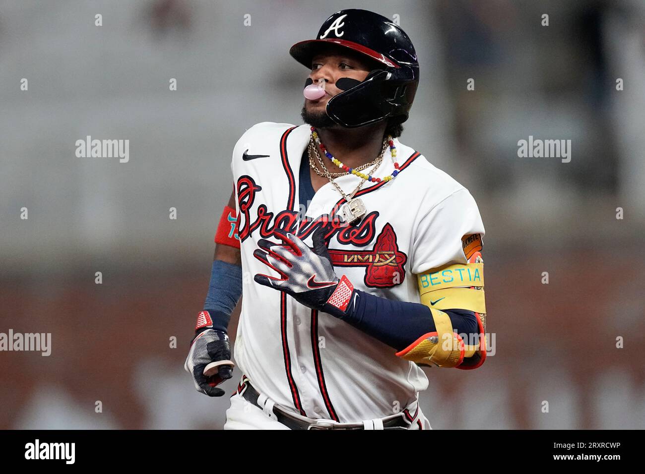 Atlanta Braves' Ronald Acuna Jr. (13) blows a bubble as he runs the ...
