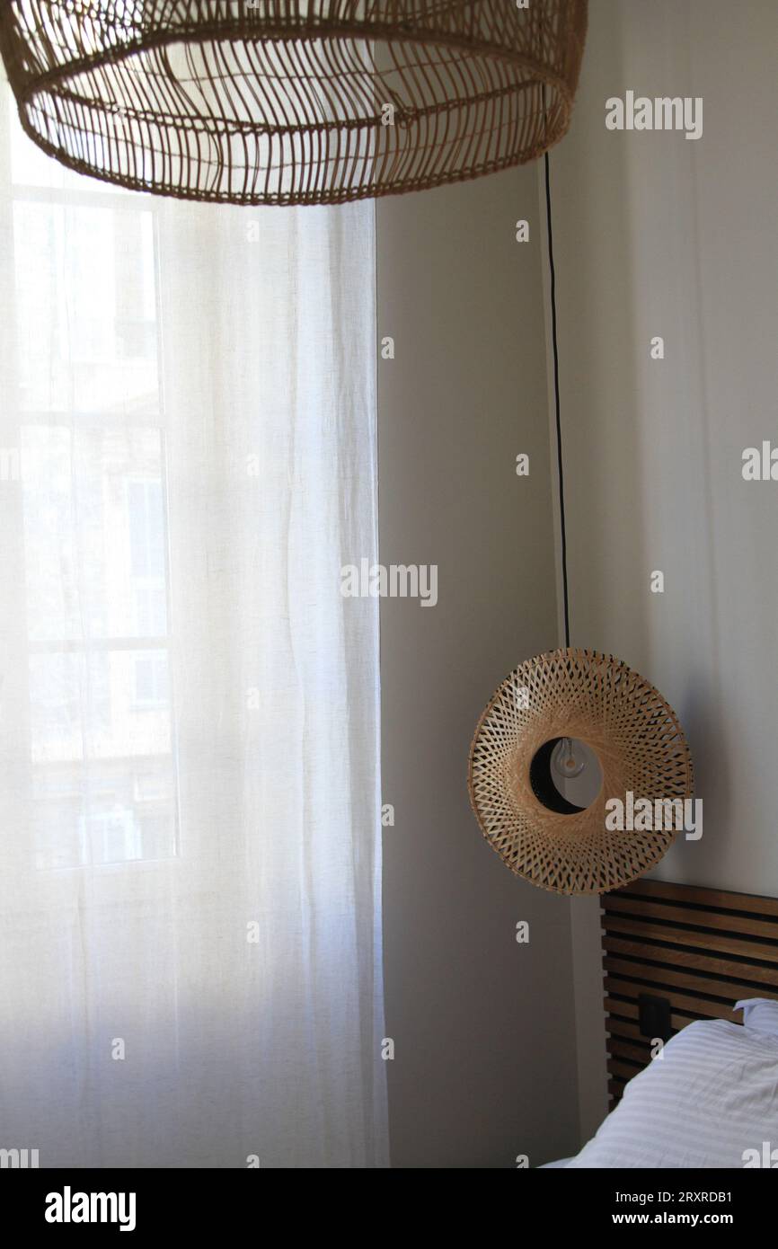 Corner of a room with tall window and modern wicker pendant light ...