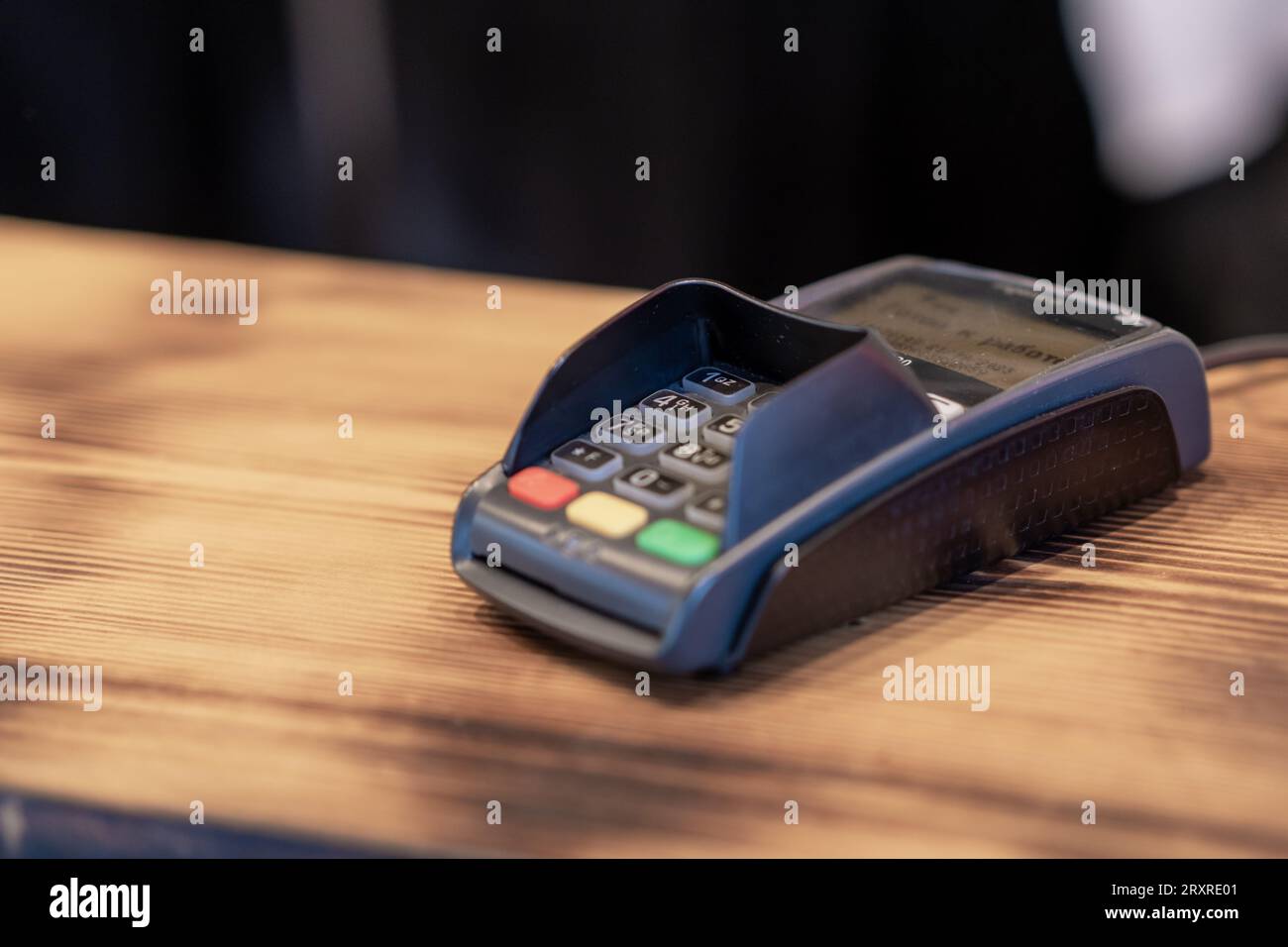 Terminal for cashless payment on a wooden background in a cafe Stock ...