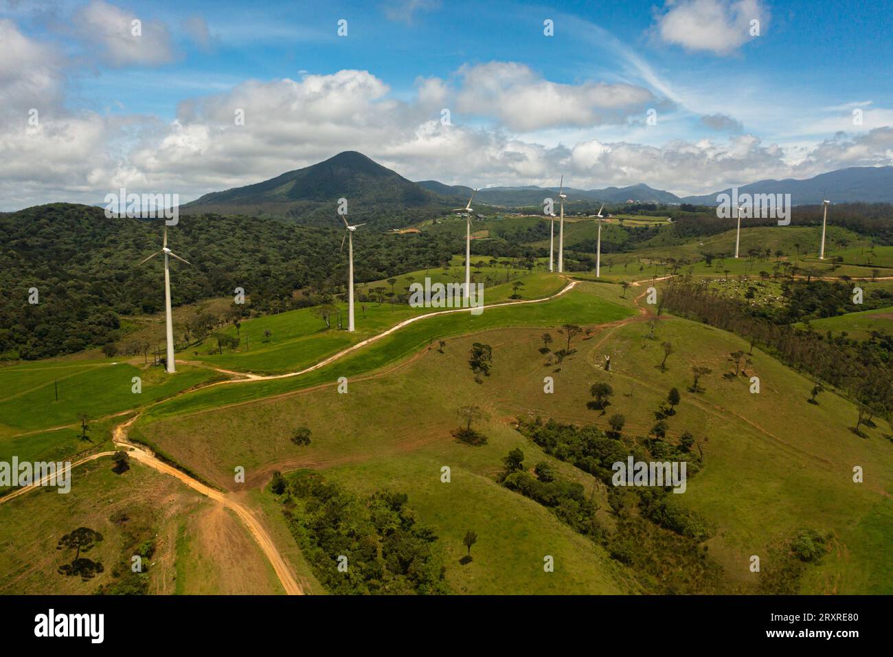 Aerial view of Wind Farm with wind turbines on the green hills in the ...
