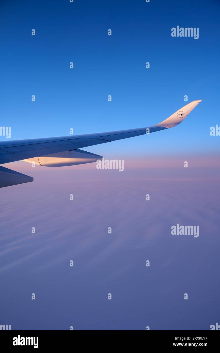 Lufthansa airplane wing and a view on a North Pole snowy landscape ...