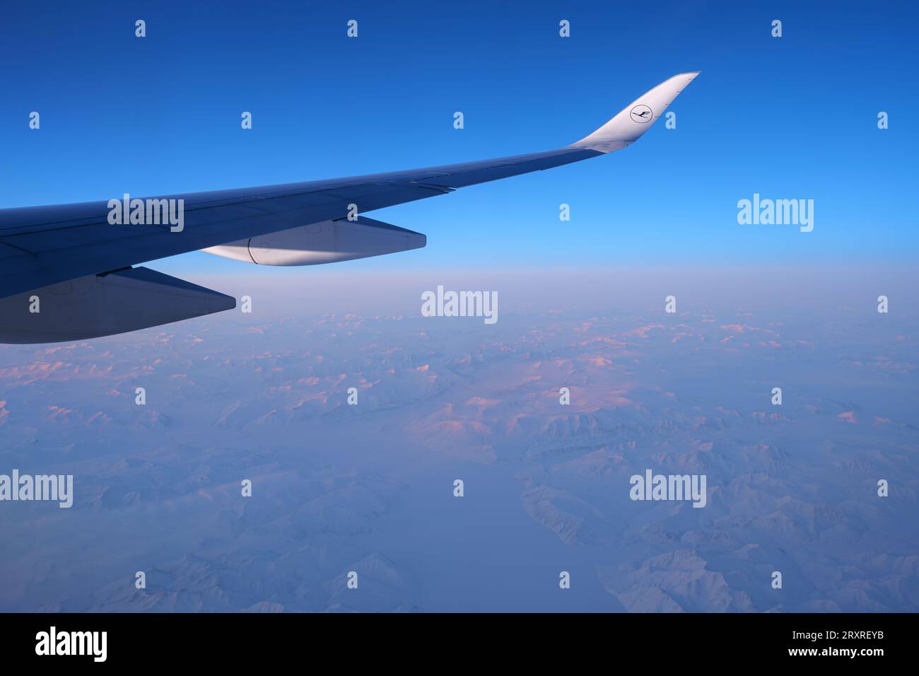 An airplane wing and a view on a North Pole snowy landscape while ...