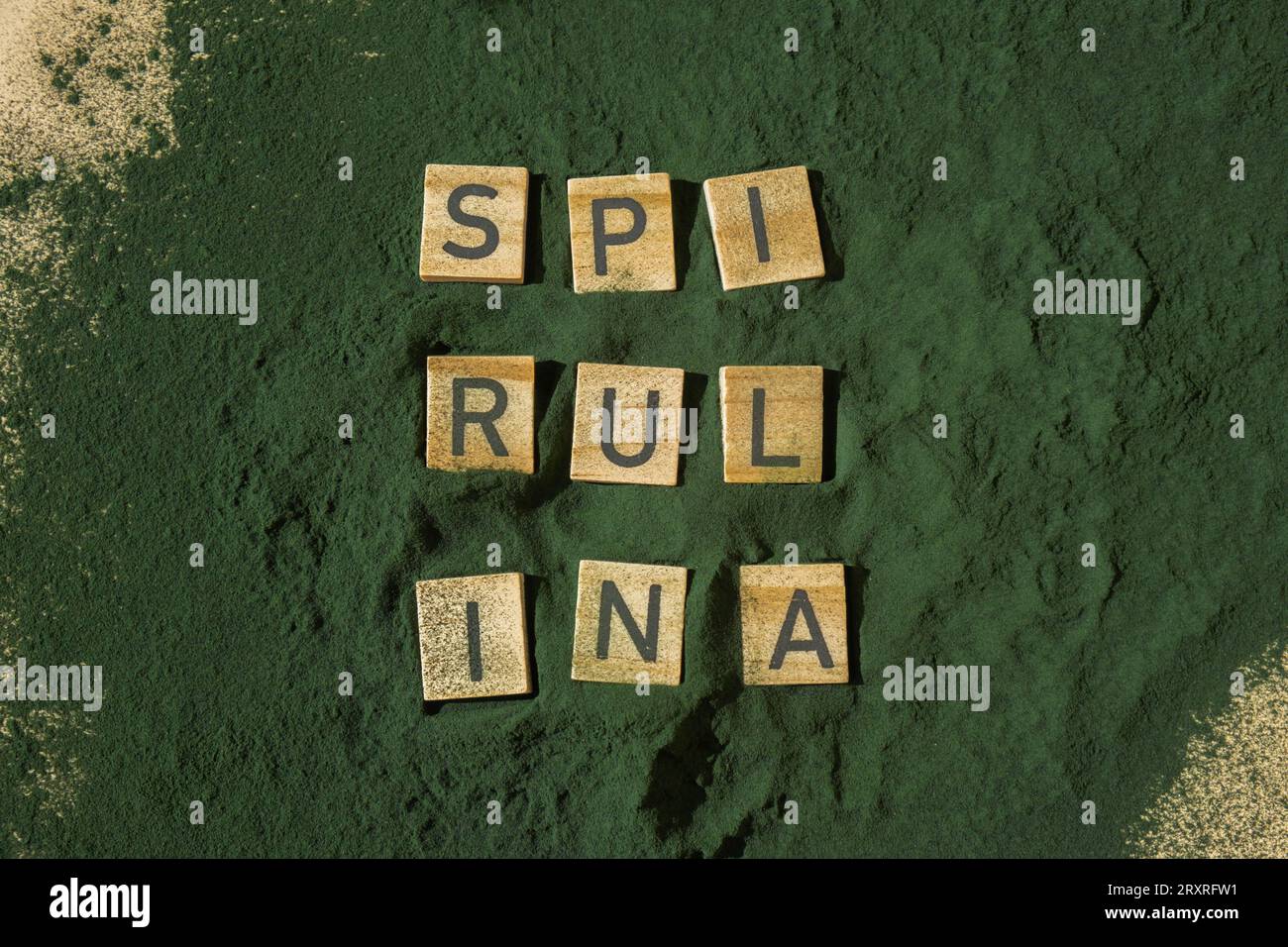 Wooden blocks with text SPIRULINA chlorella on background of algae ...