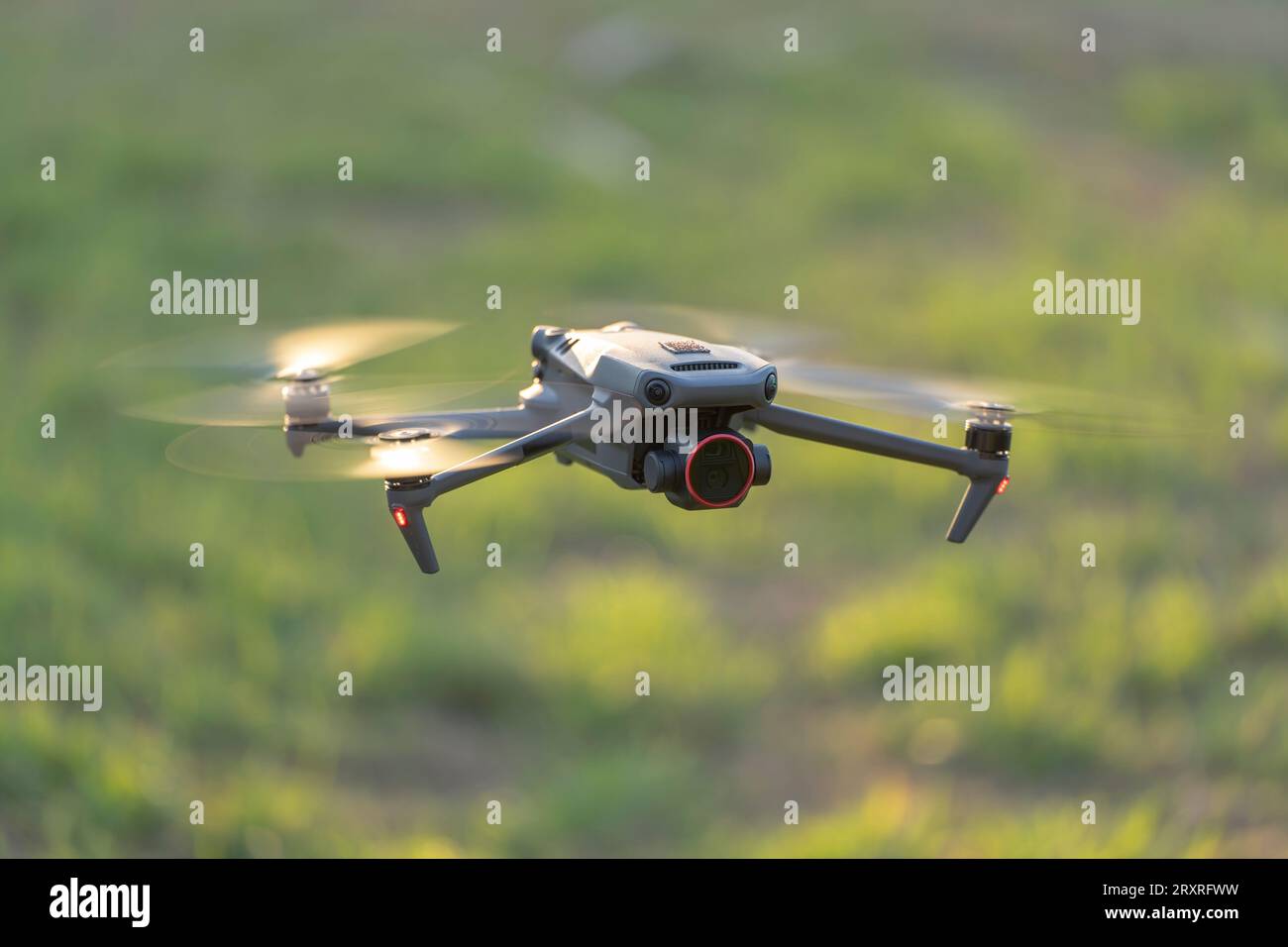 Drone aircraft with blurred fast rotating propellers and video camera ...