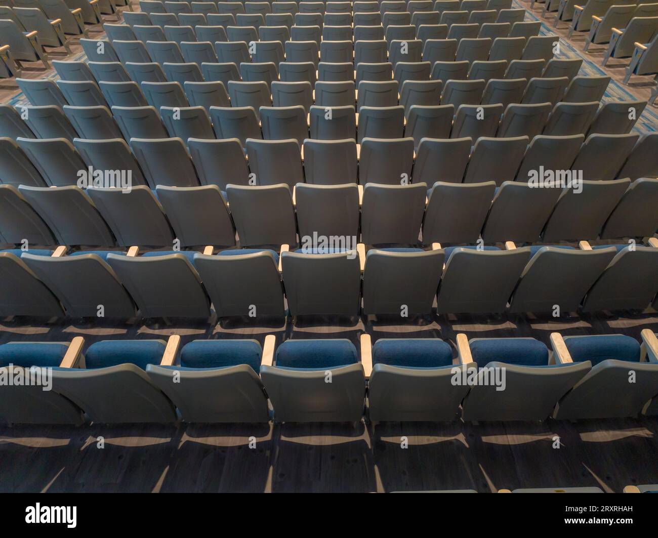 Overhead view of empty gray and blue theater, auditorium seats, chairs ...