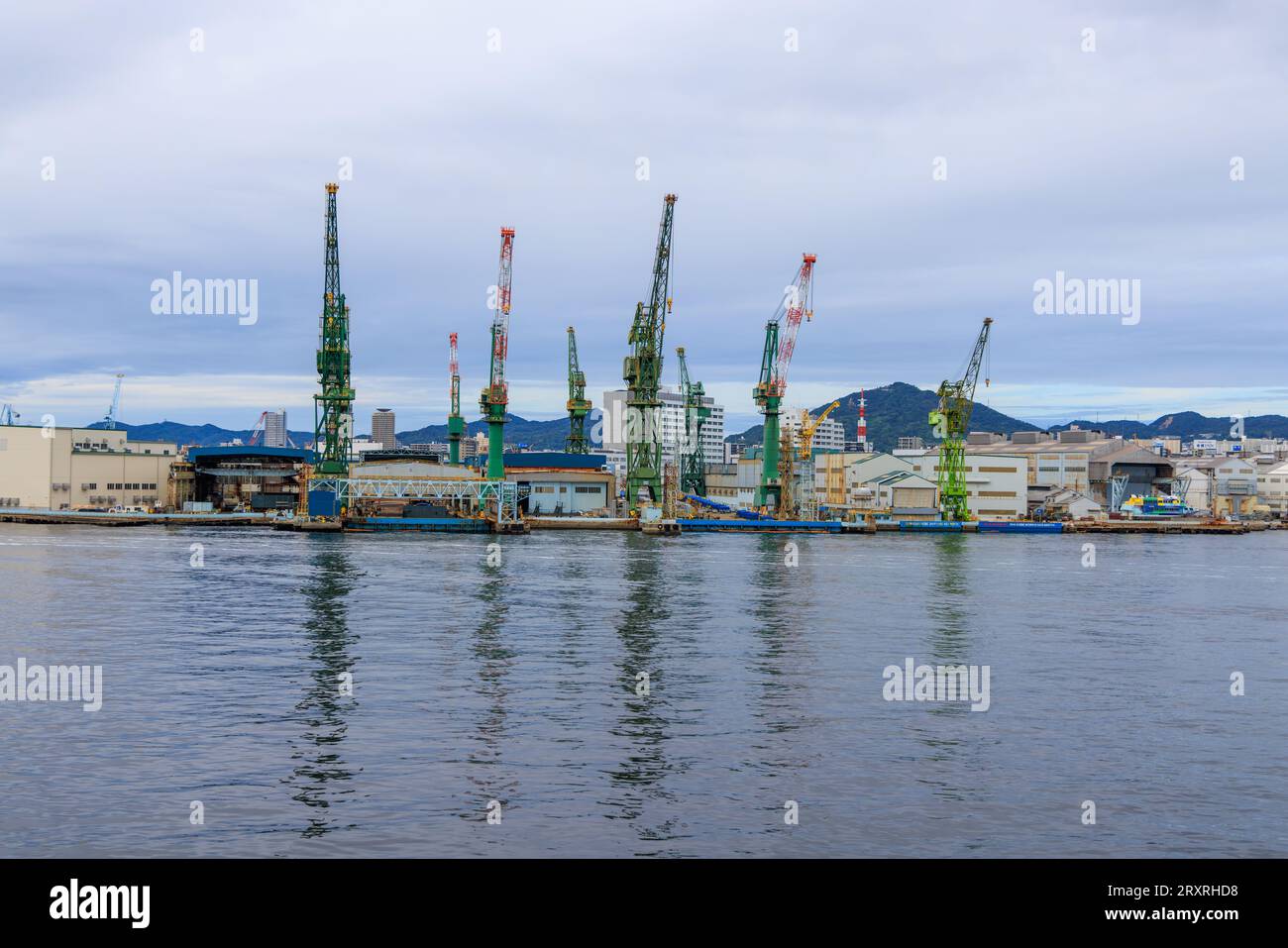 Cargo loading cranes tower over empty dock in industrial harbor Stock ...