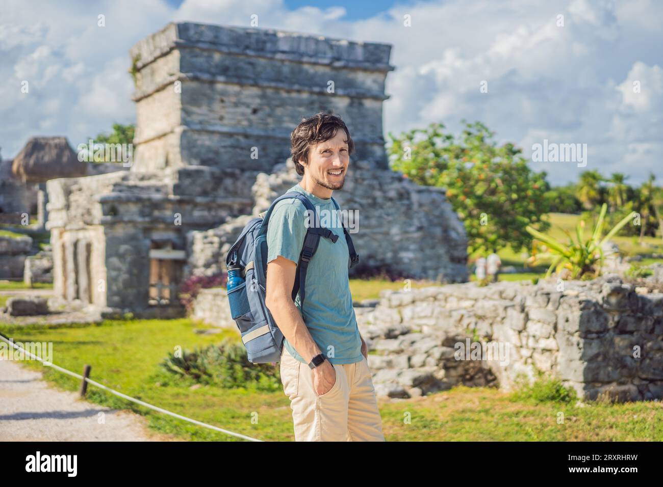 Male tourist enjoying the view Pre-Columbian Mayan walled city of Tulum ...