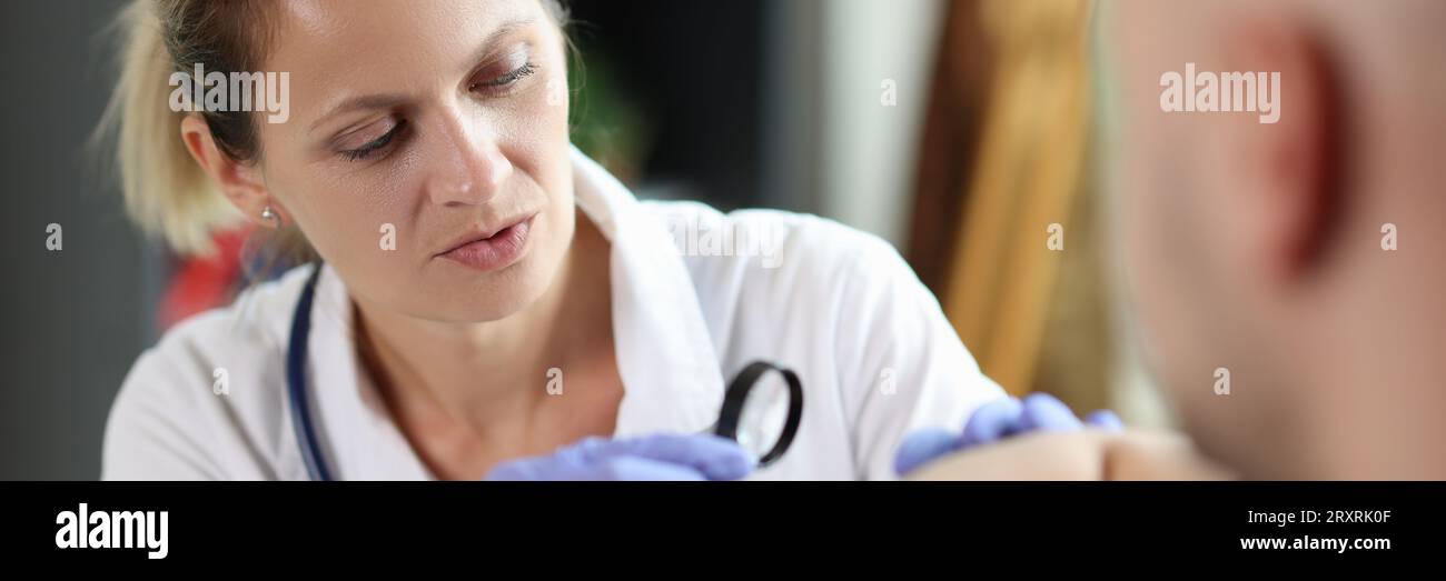 Dermatologist conducts medical examination on skin of male patient with ...