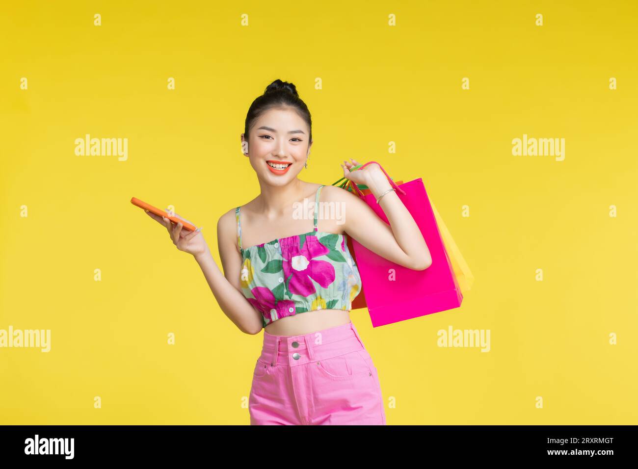 Women carrying a lot of colorful shopping bags and mobile phone ...