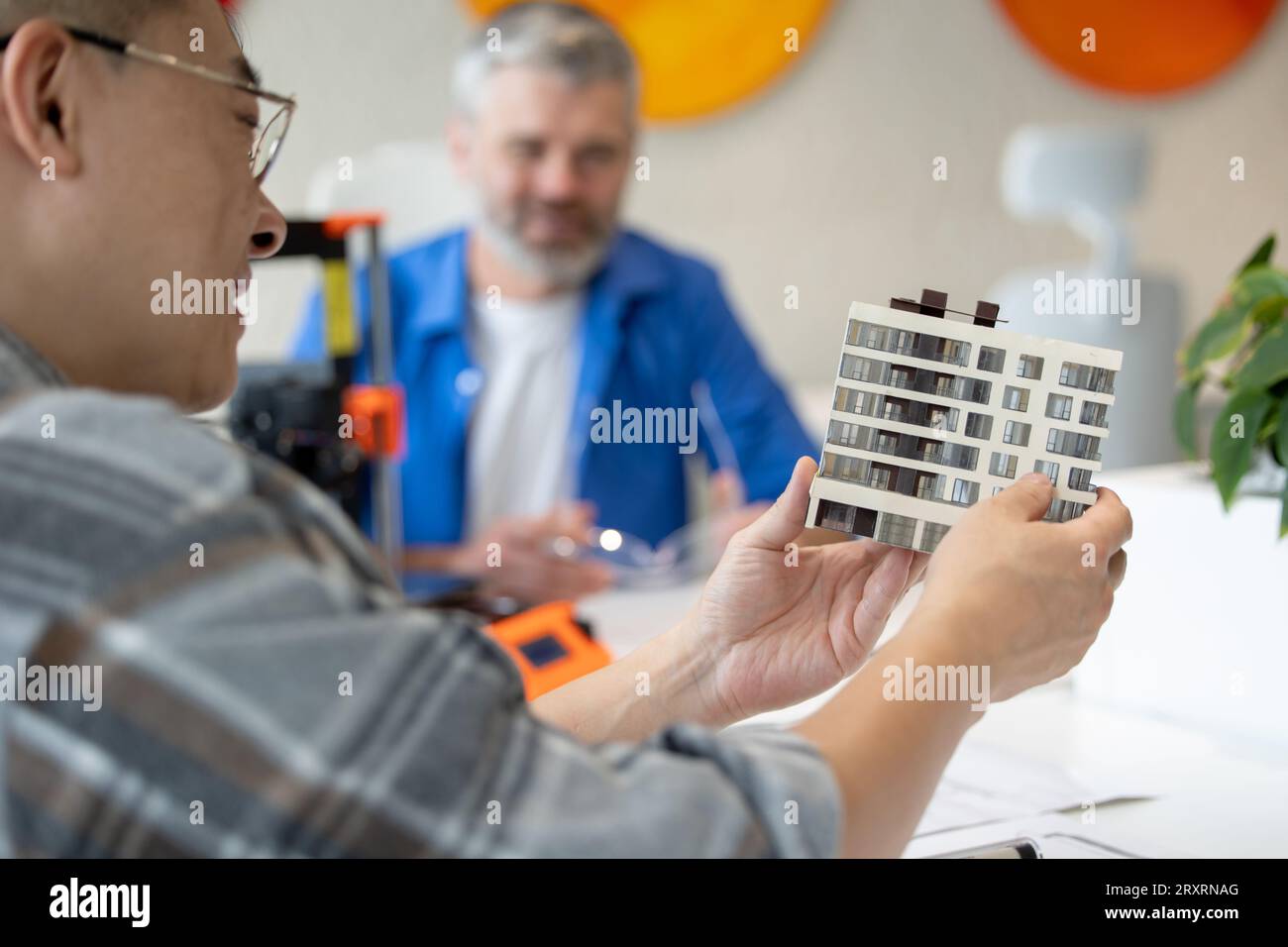 Architects making house model working with 3D printer, creating process ...