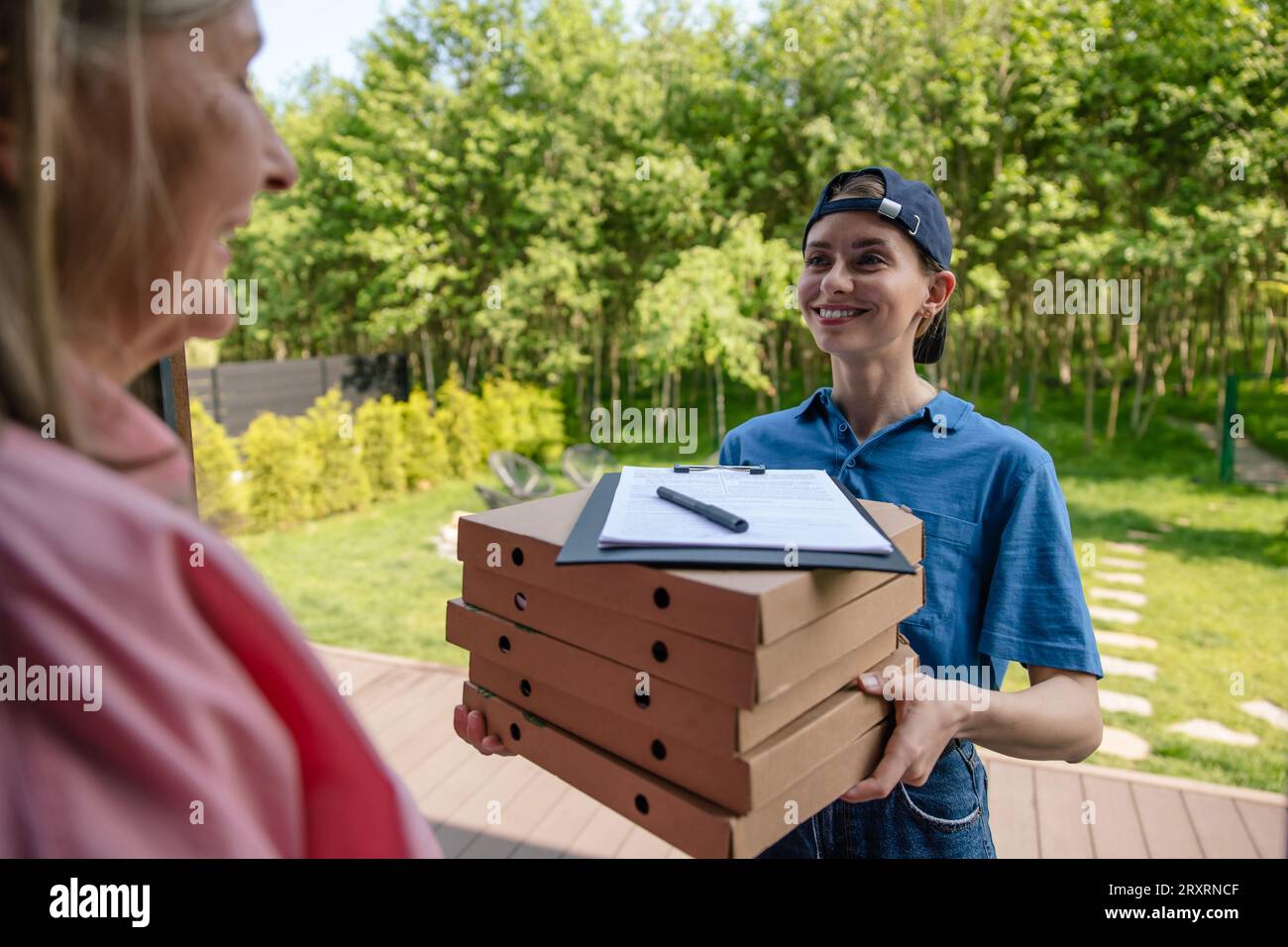 Girl in uniform delivering parcel hi-res stock photography and images ...