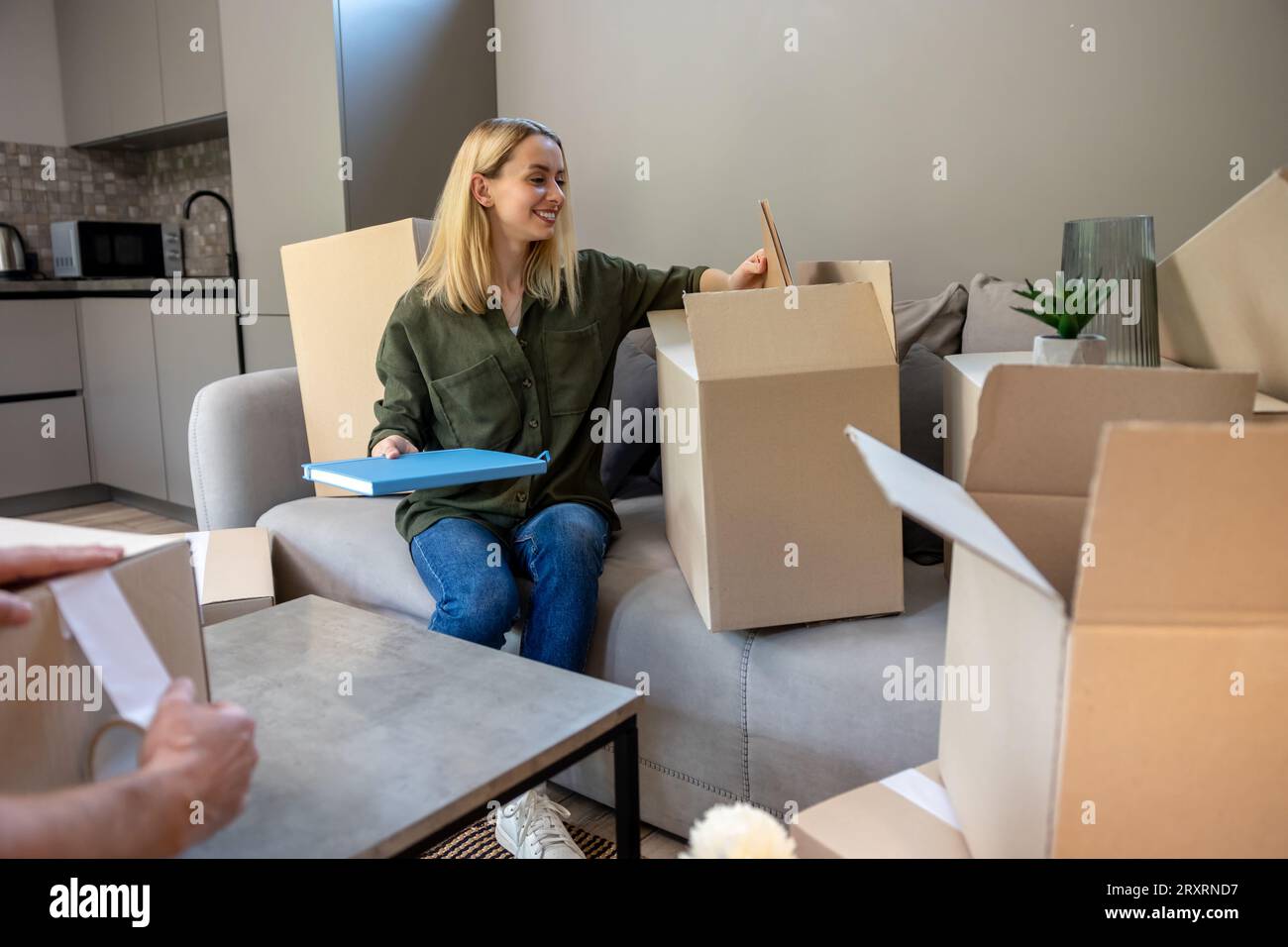 Two people looking busy while packing the boxes for relocation Stock ...