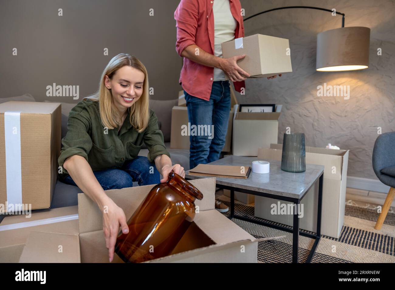 Young family looking involved while packing boxes for the move Stock ...