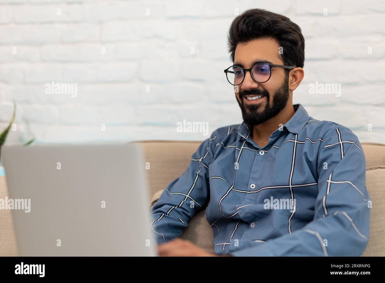 Smiling millennial man working hi-res stock photography and images - Alamy