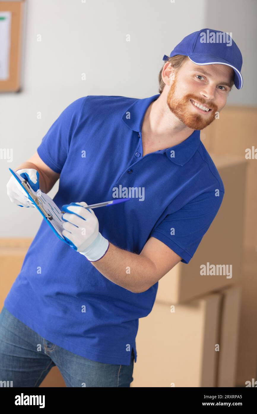 delivery man signing clipboard receipt of delivery package Stock Photo ...