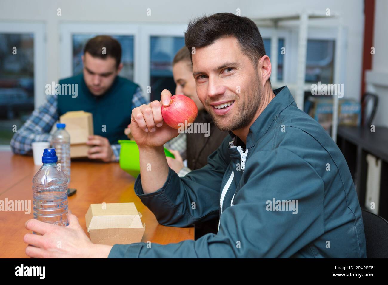 male manual worker eating apple for lunch Stock Photo - Alamy