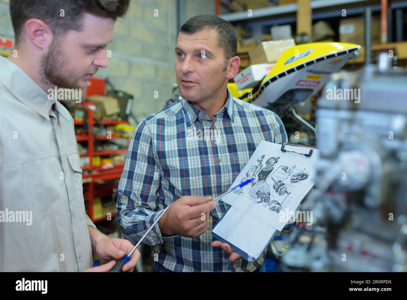 portrait of mechanical engineering checking drawing Stock Photo - Alamy