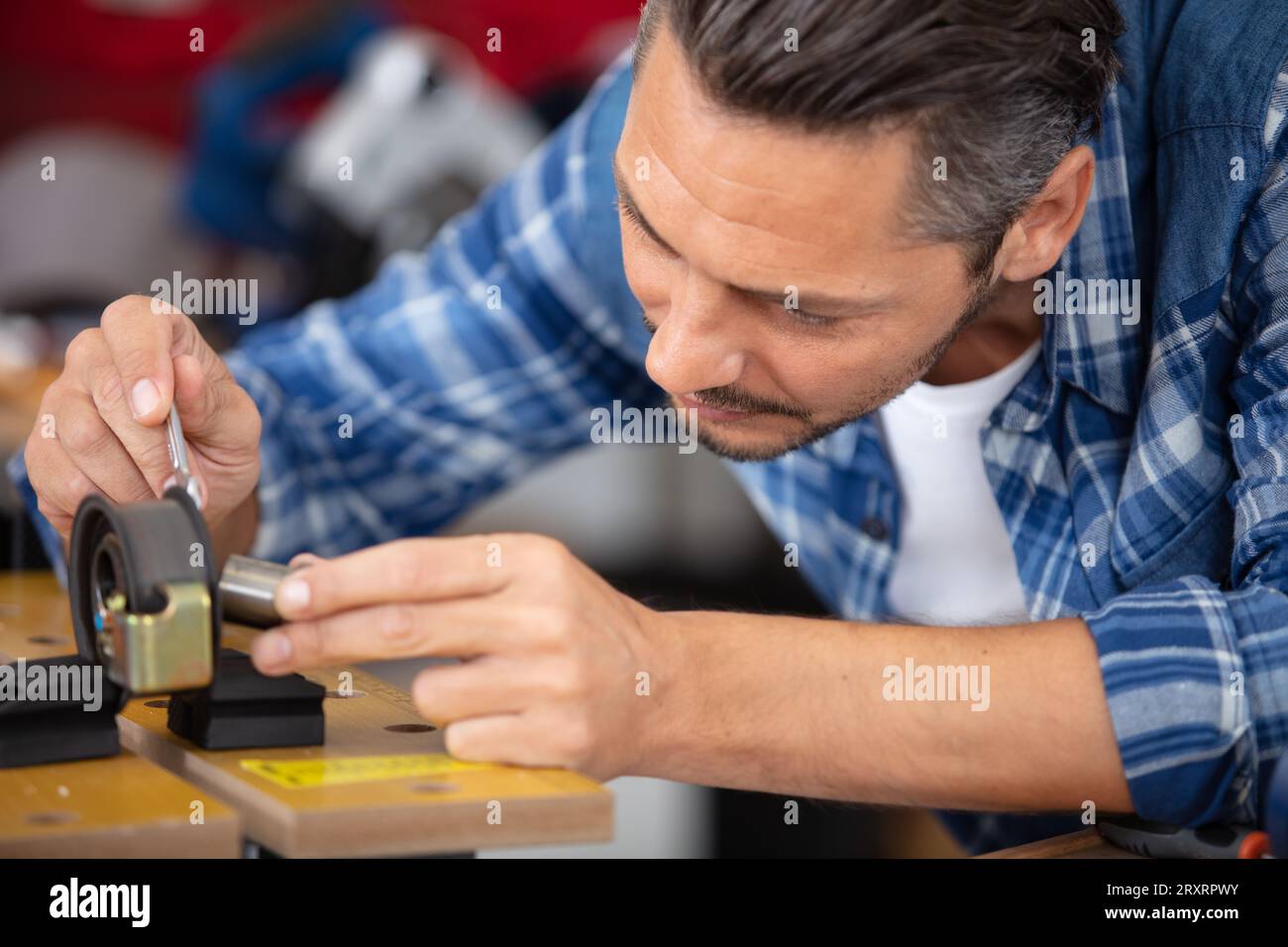 engineer inserting a bearing held in a clamp Stock Photo - Alamy
