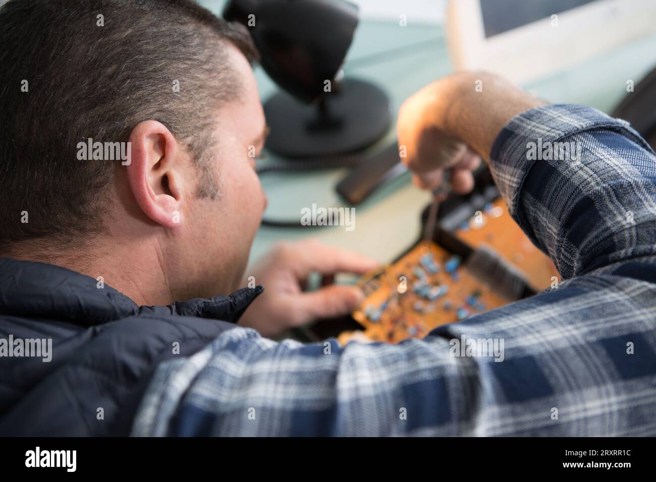 man hand and a set of different bolts Stock Photo - Alamy