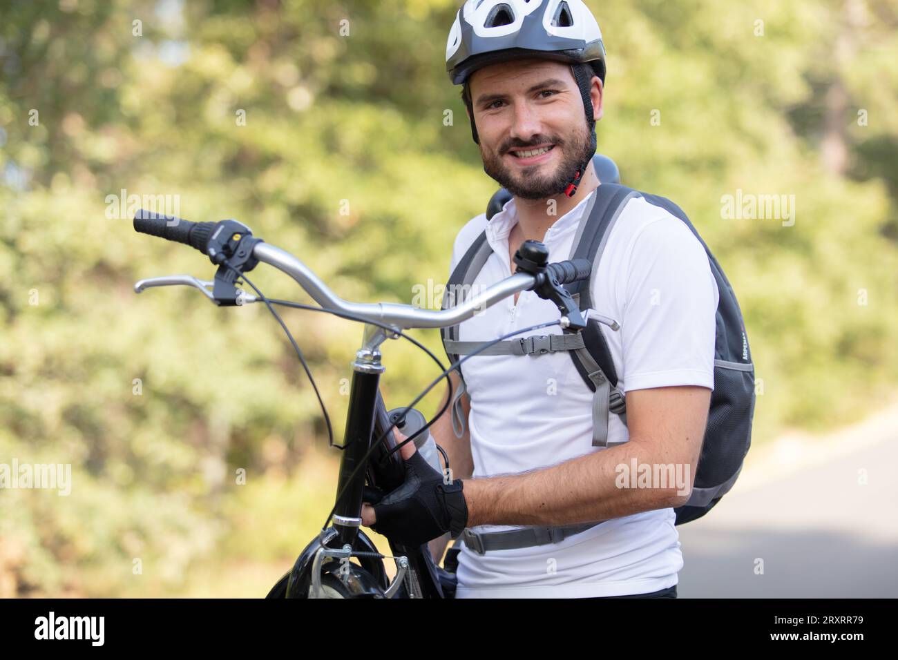 cyclist carrying his bike on rocky terrain Stock Photo - Alamy