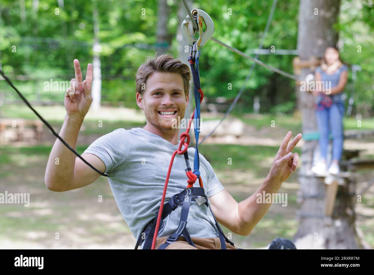 Man trying climb rope hi-res stock photography and images - Alamy