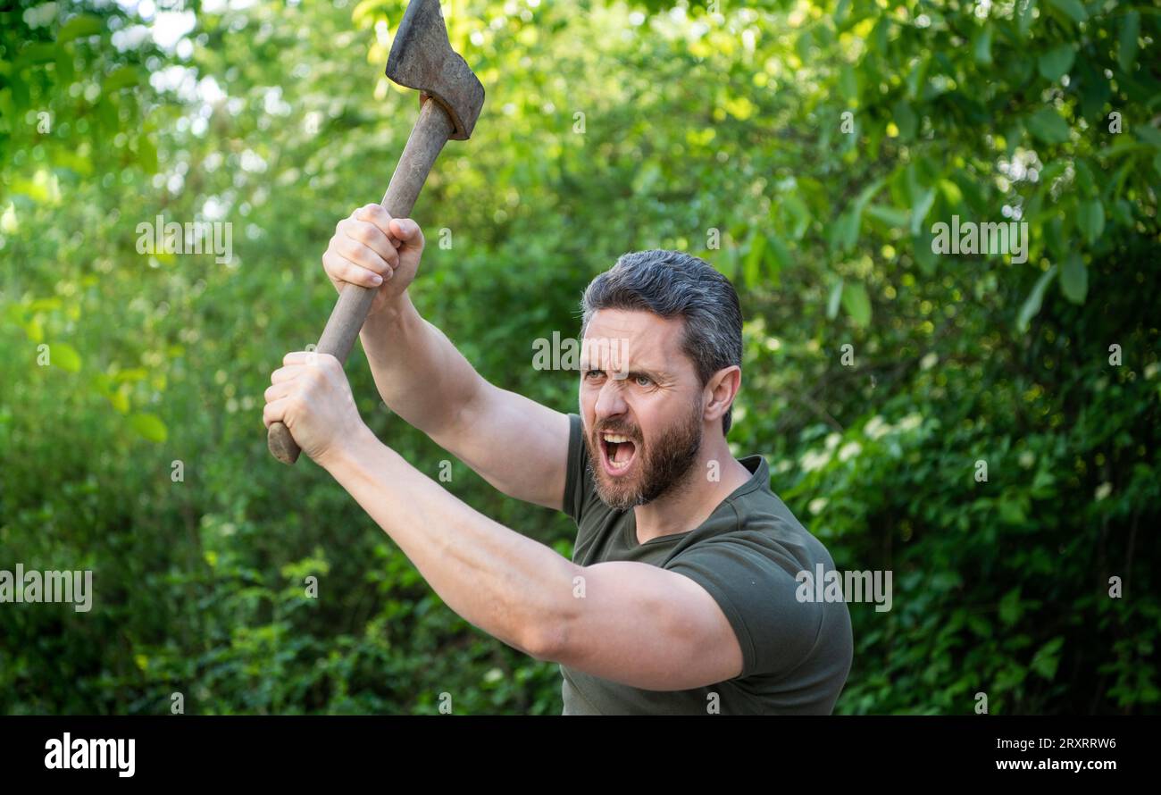 aggressive man holding axe. aggressive man with axe wearing shirt ...