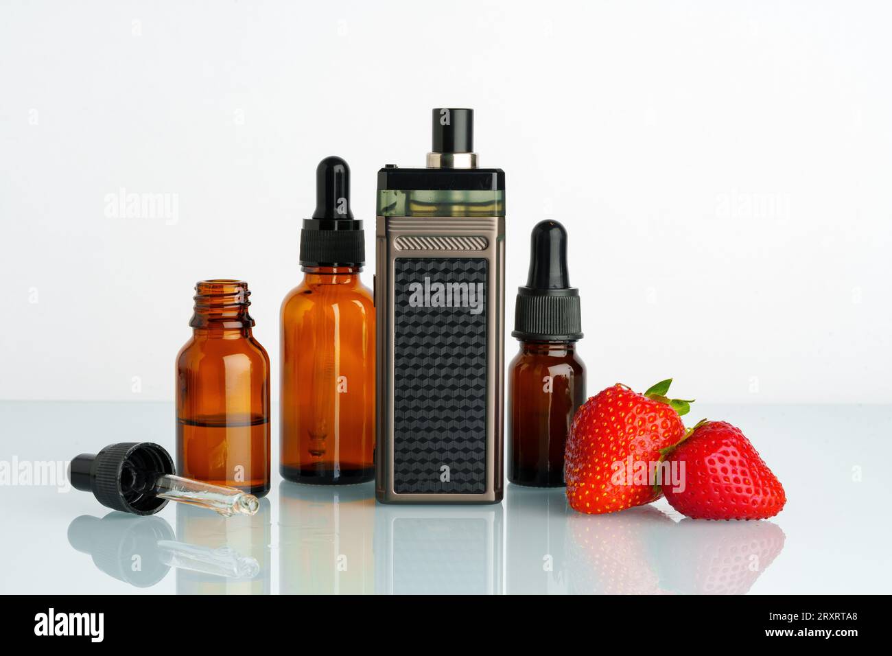 Electronic cigarette liquid with strawberry flavor on white background ...