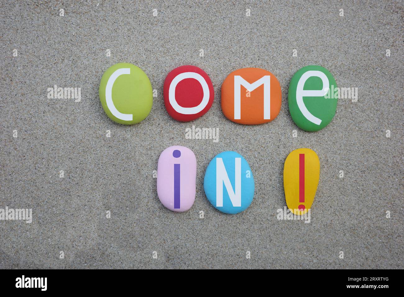 Come in, creative text composed with multi colored stone letters over ...