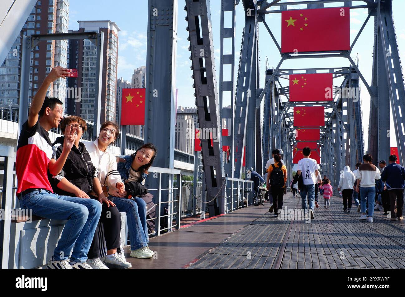 National flags are hung up on the Songhua River Railway Bridge to ...