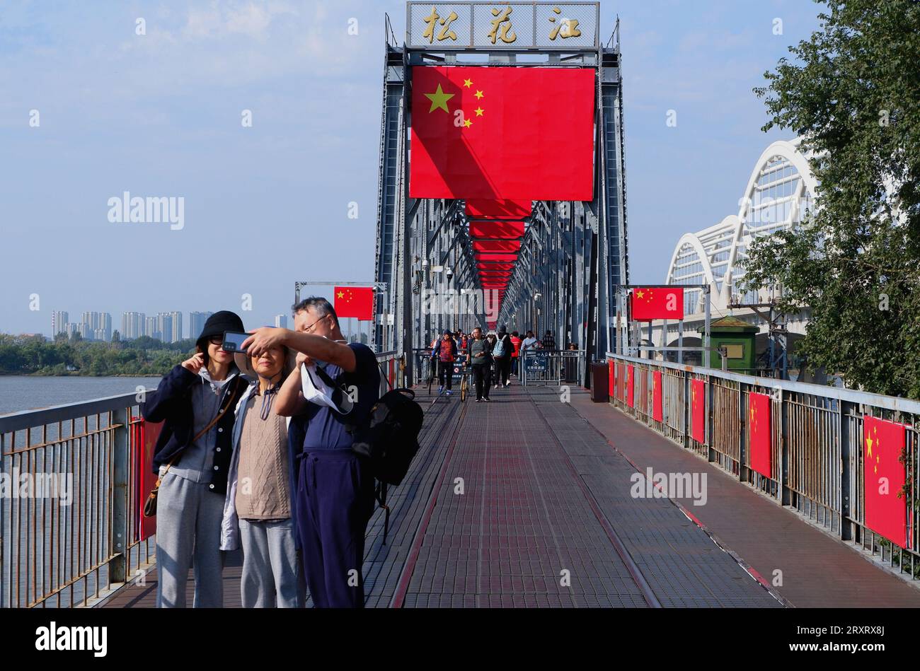 National flags are hung up on the Songhua River Railway Bridge to ...