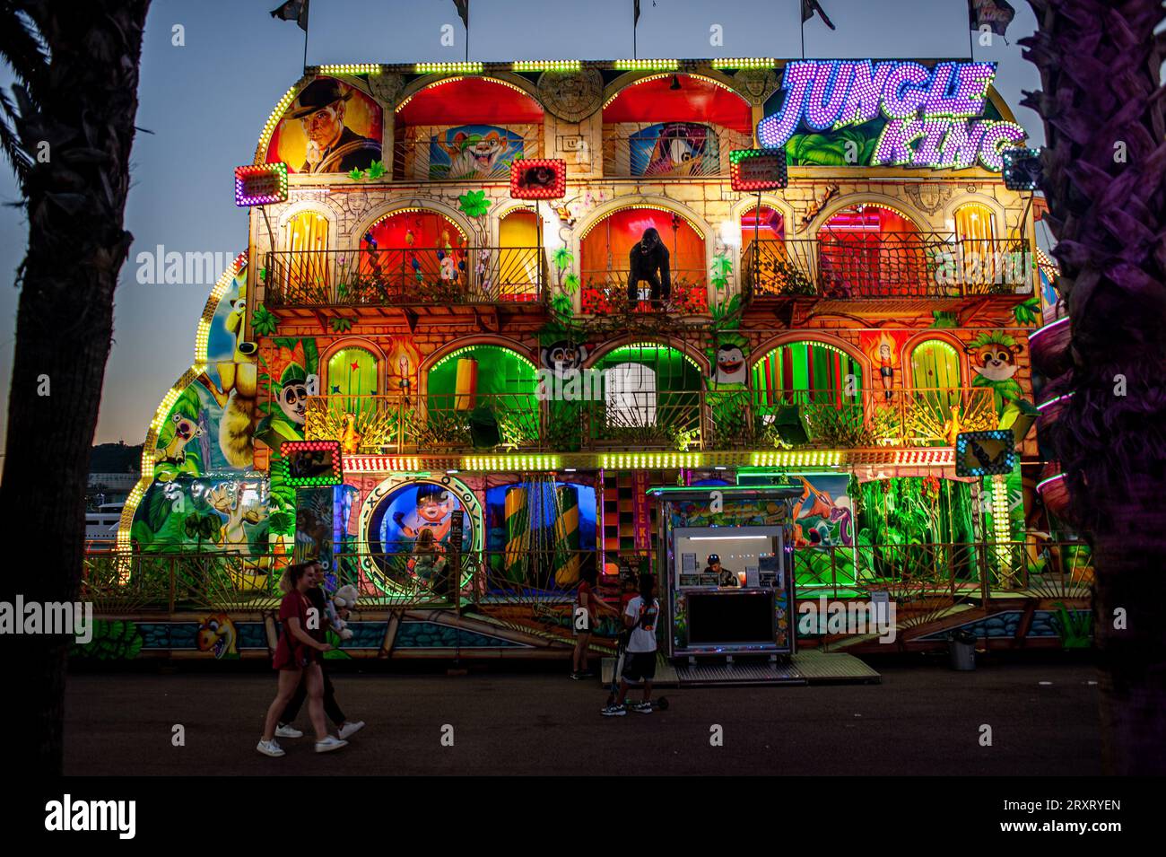 September 26, 2023, Barcelona, Spain: People walk along a funfair ...
