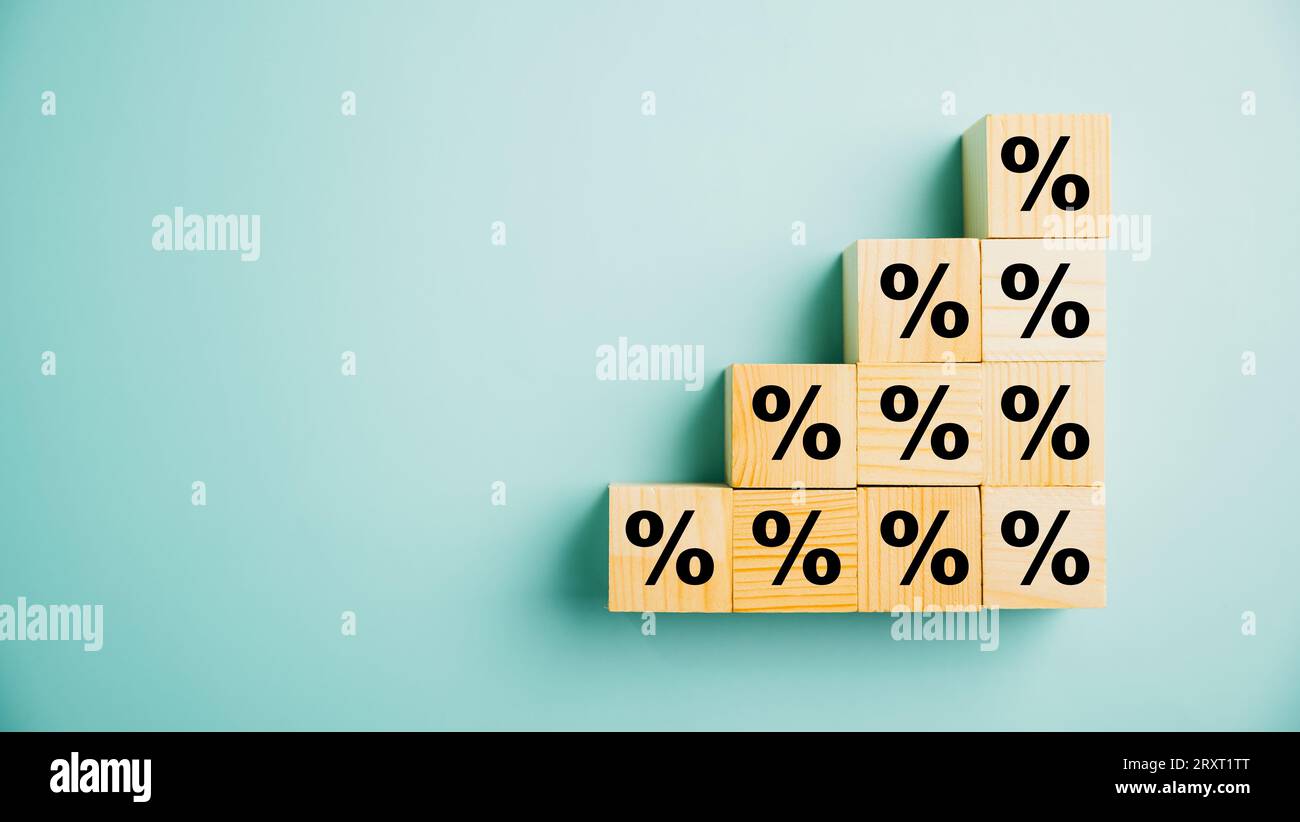 Businessman's hand arranging a wood cube block with a percentage symbol ...